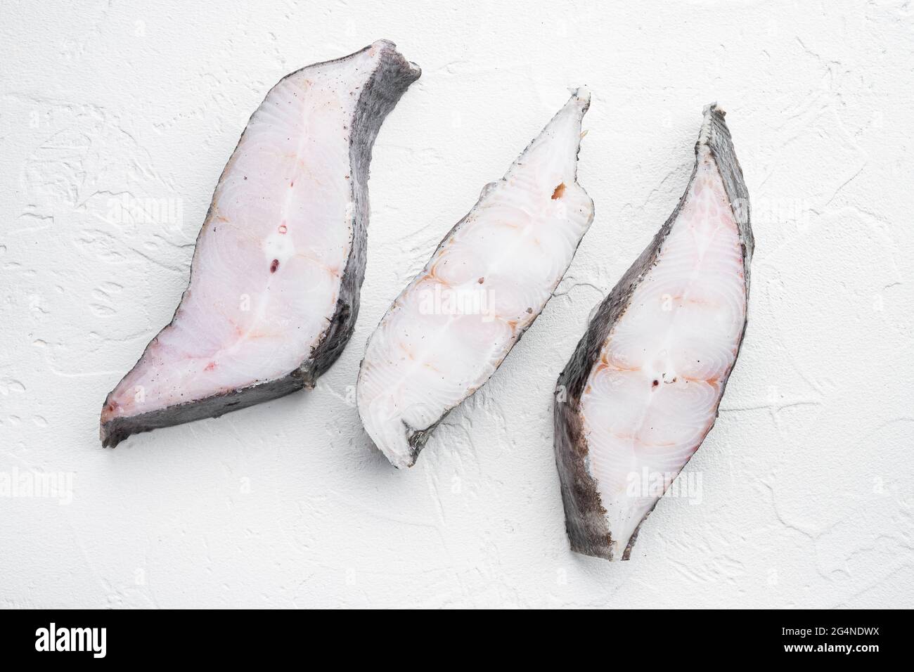 Frozen fish steak set, on white stone table background, top view flat ...