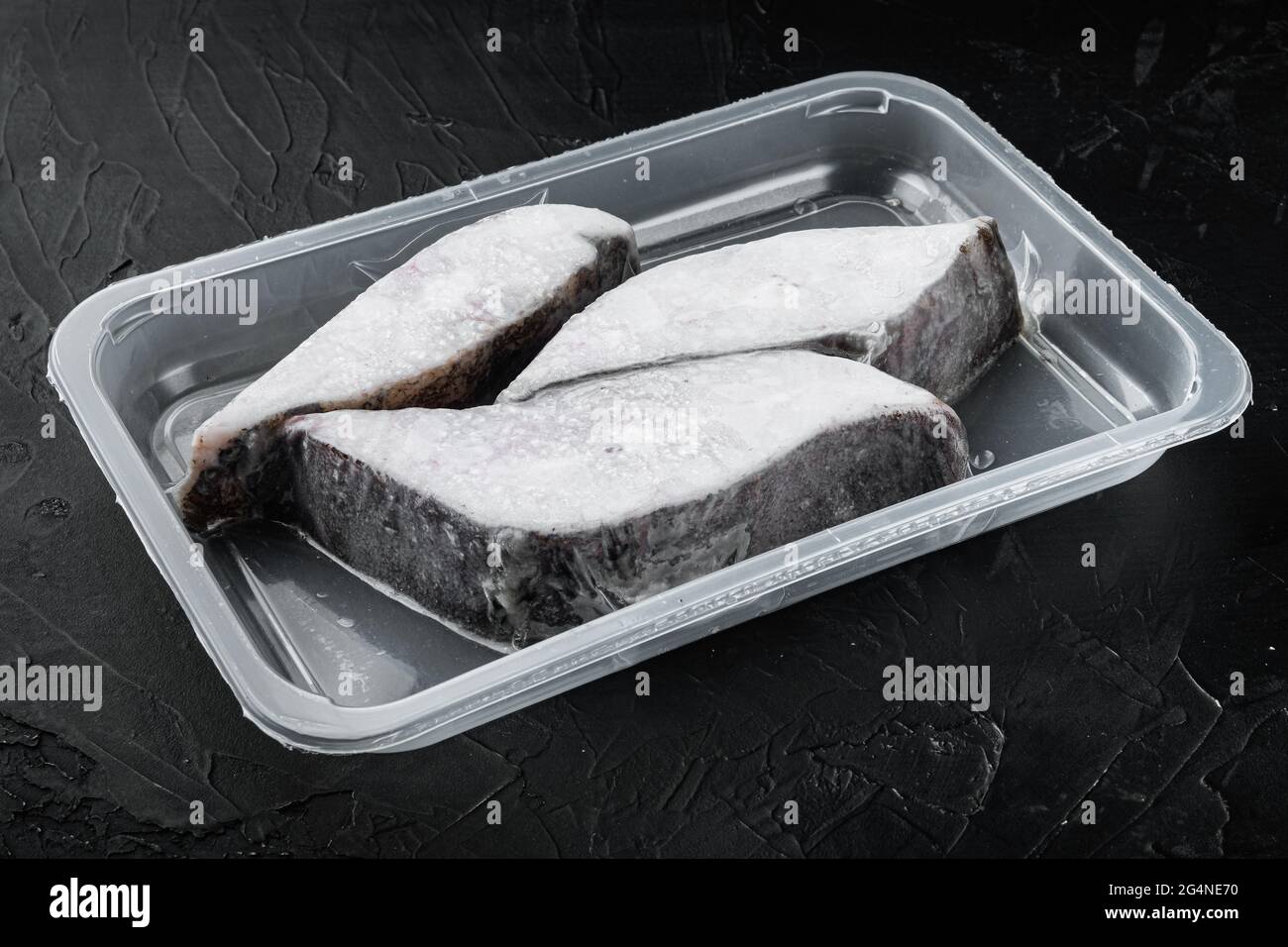 Fish fillet frozen pack set, on black dark stone table background Stock ...
