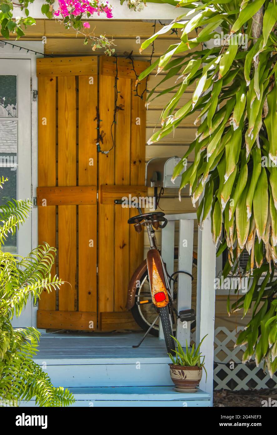 Entrance and porch to Key West House with rustic hurricane shutter by ...