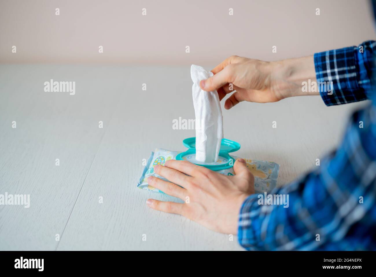 a caucasian male person taking a wet hygiene napkin and ckean his dirty ...