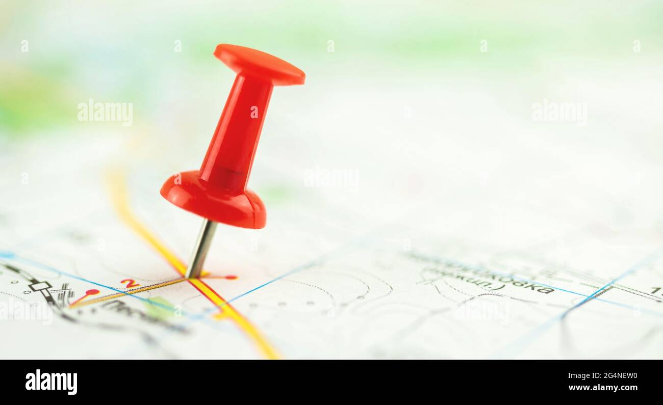 Close-up of a red push pin on the city map, selective focus composition ...