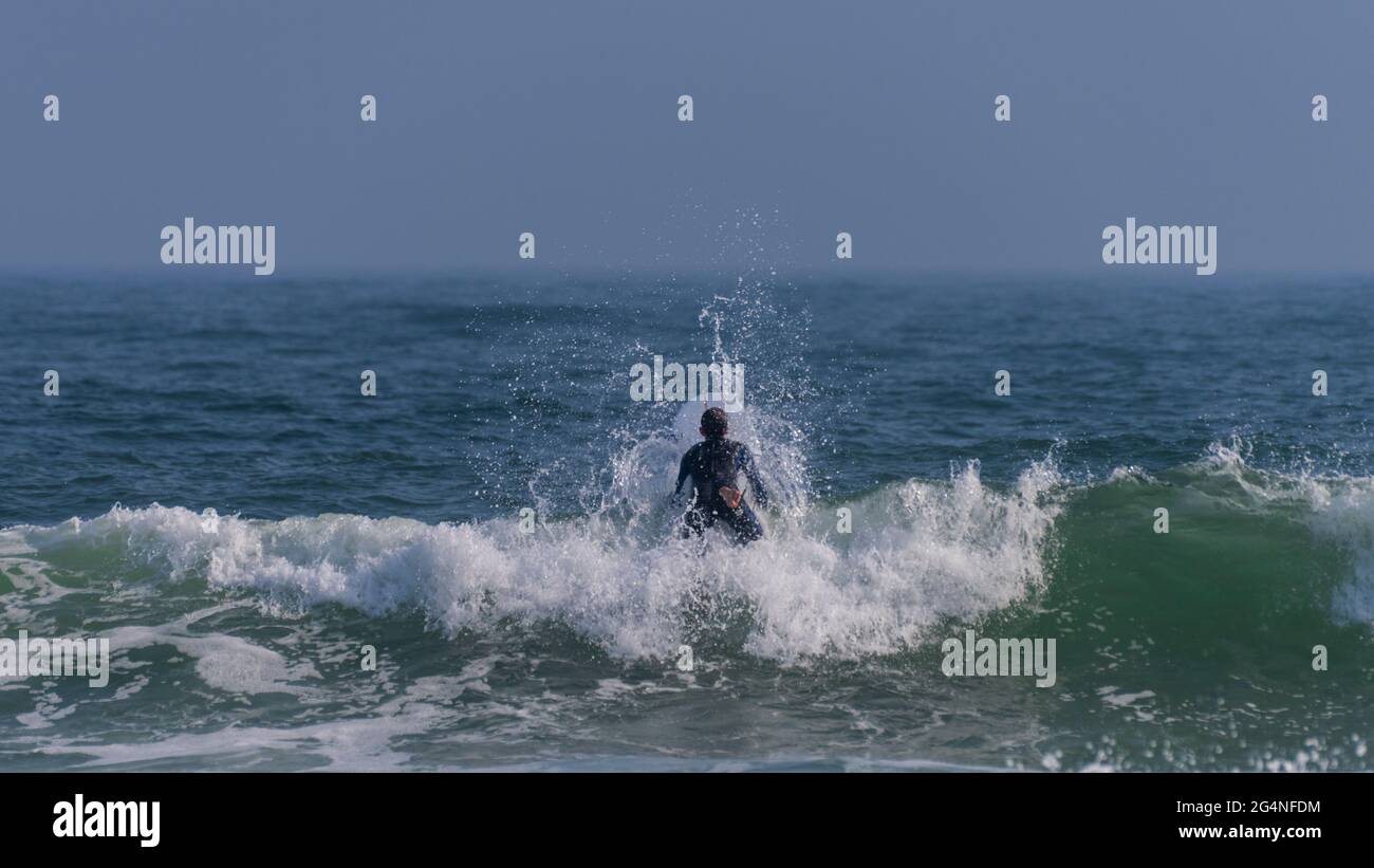A man surfs near the beach at the Johnson Beach National Seashore in ...