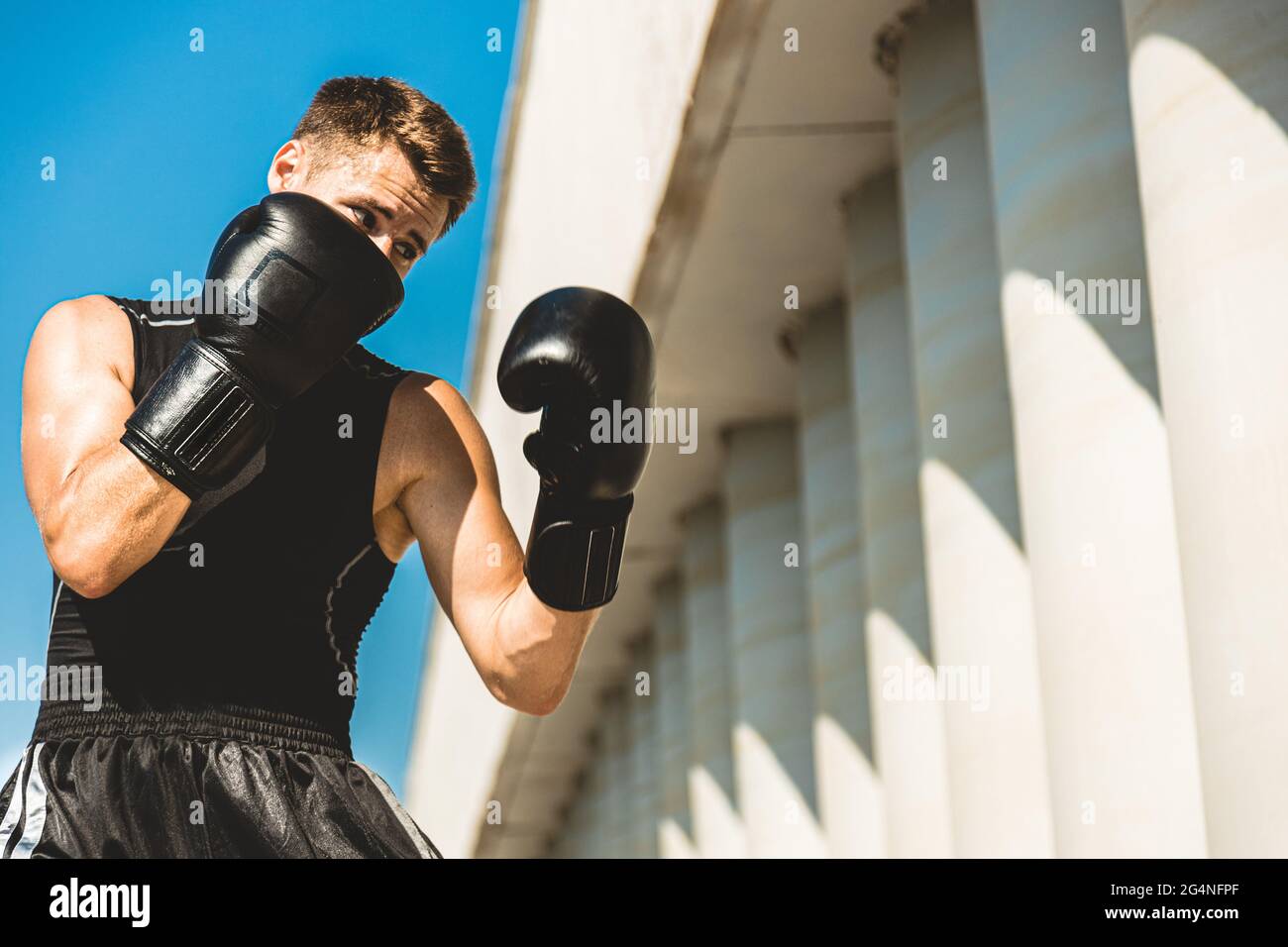 Man exercising and fighting in outside, boxer in gloves. male boxer ...