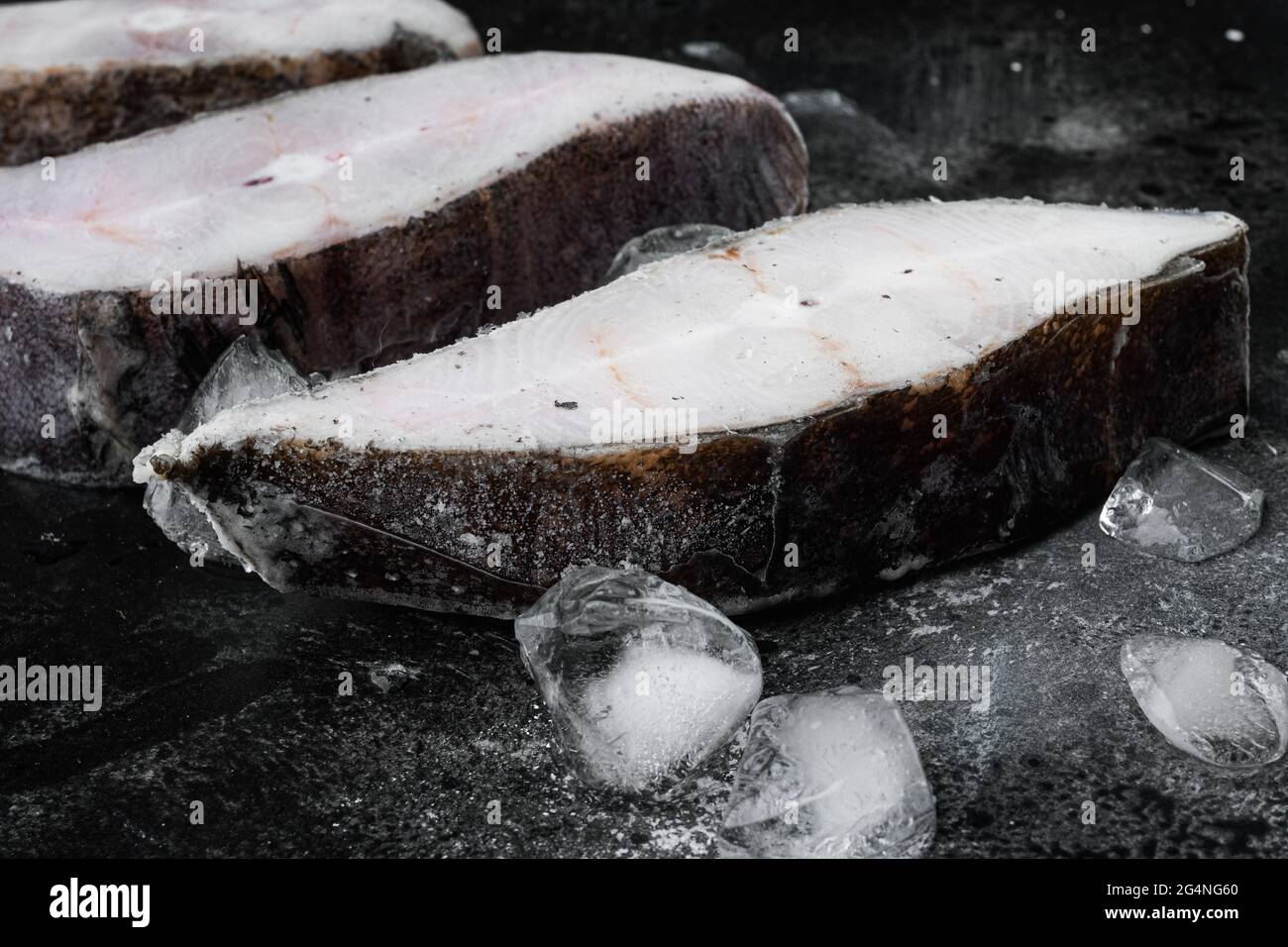 Slices of white fish seafood market set, on black dark stone table ...