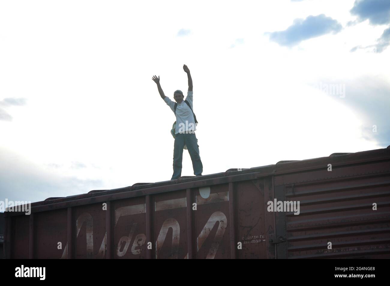 Man standing atop a train car on the train they call La Beastia (The ...
