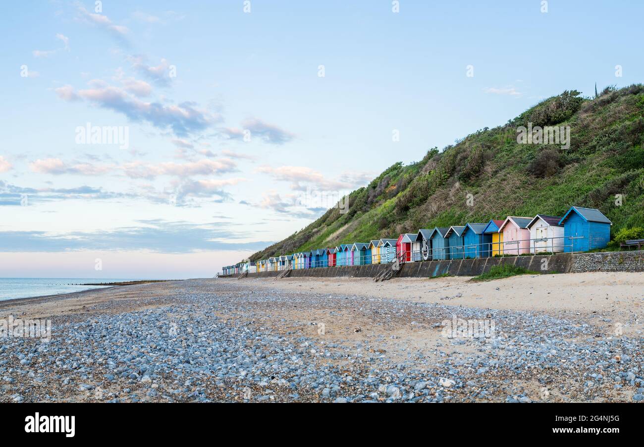 Pretty beach huts lined up on the East beach of Cromer seafront on the ...