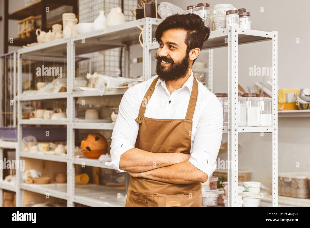 Portrait of a young attractive businessman craftsman with a beard and ...