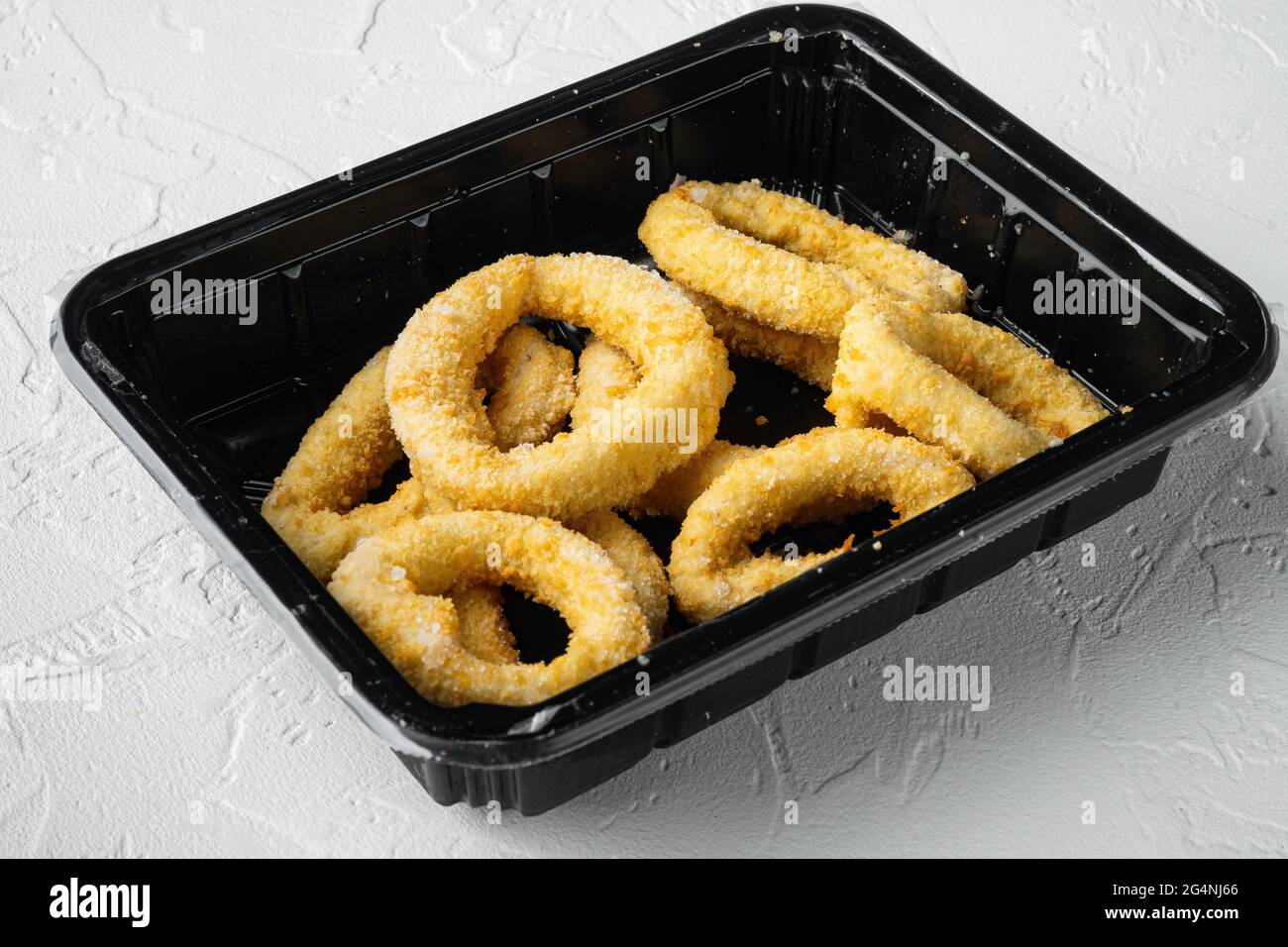 Raw Crispy deep fried onion or Calamari ring plastic pack set, on white ...
