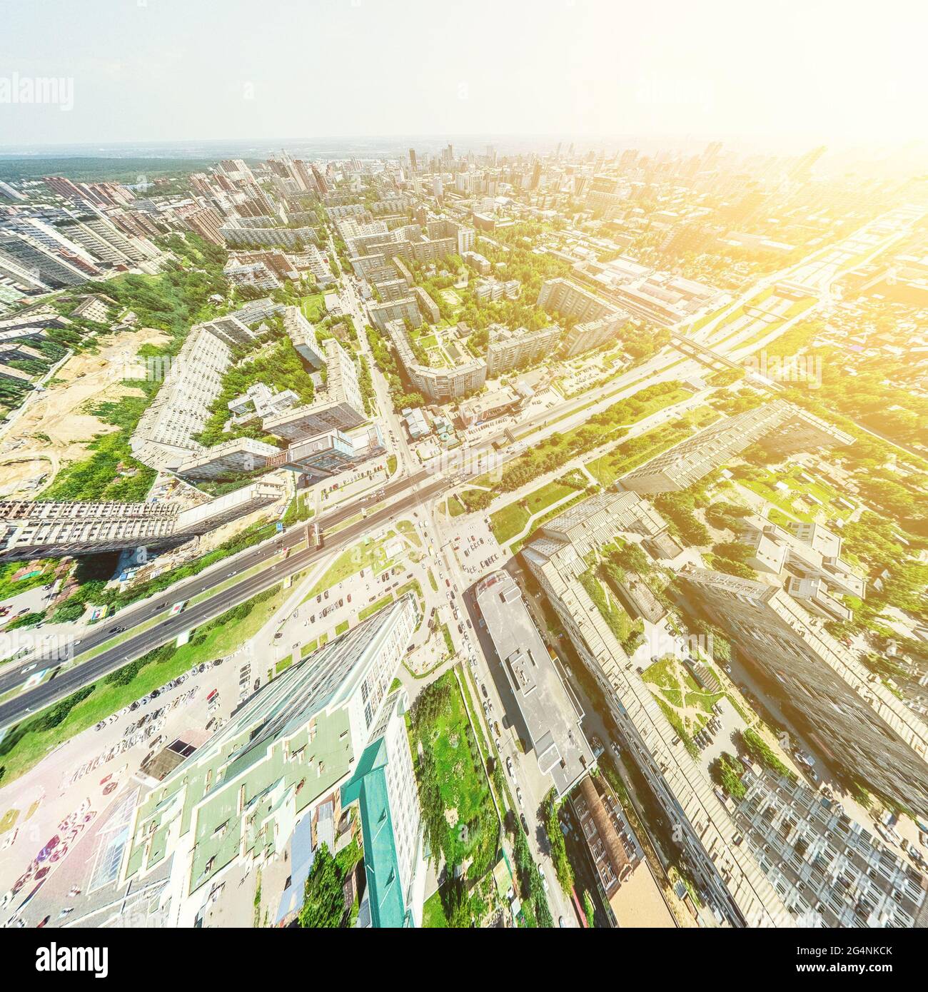 Aerial city view with crossroads and roads, houses, buildings, parks ...