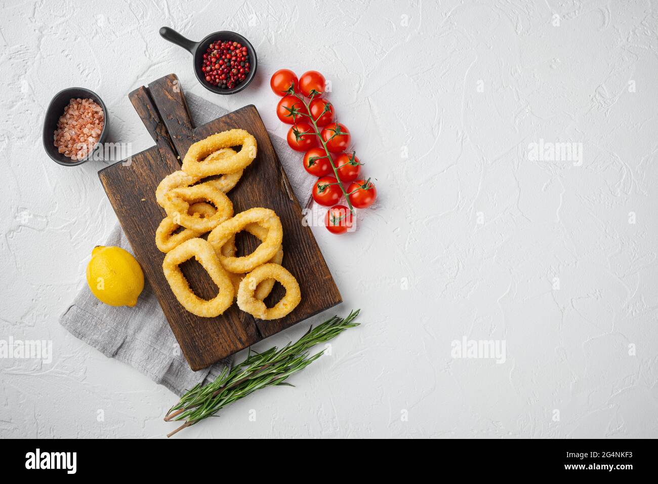 Crunchy deep fried squid or onion rings in batter set, on serving board ...