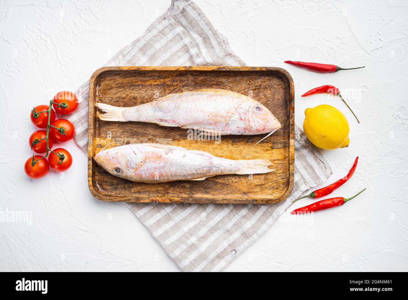 Raw Goatfish fresh whole fish set, with ingredients and herbs, on white ...