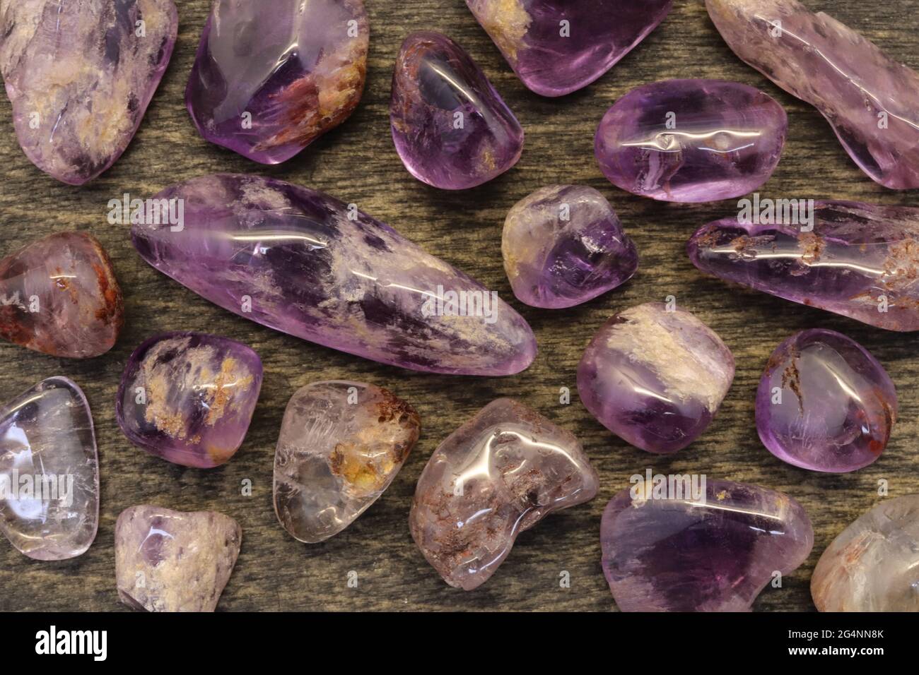 Rutilated amethyst rare jewel on black wood texture. Scarce mineral ...