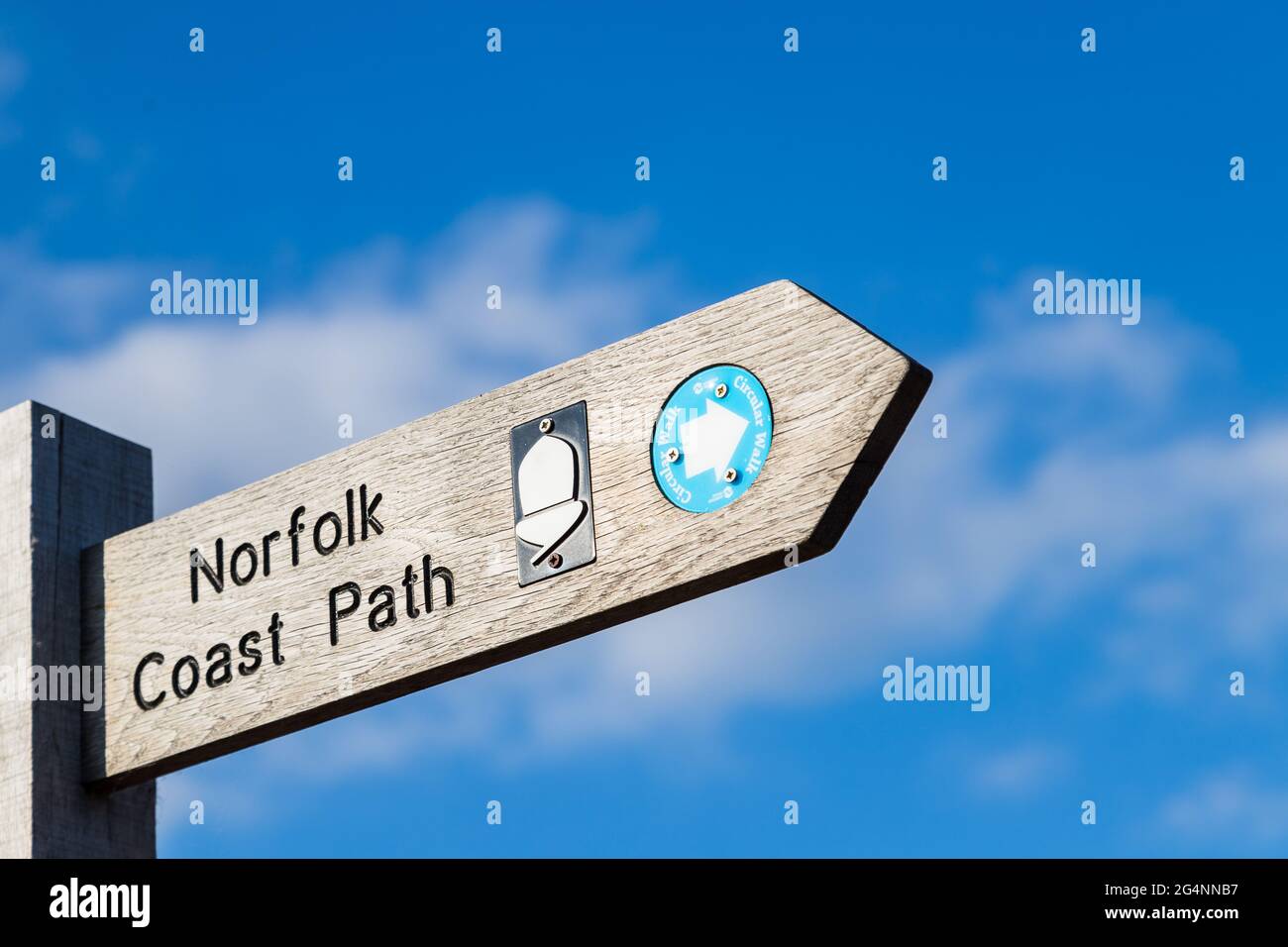 Norfolk coastal path sign captured against a blue sky in the summer of ...
