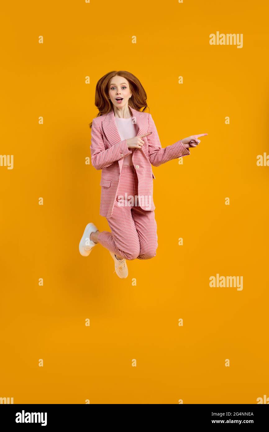 Full length photo of funny caucasian lady in pink suit jumping up high ...