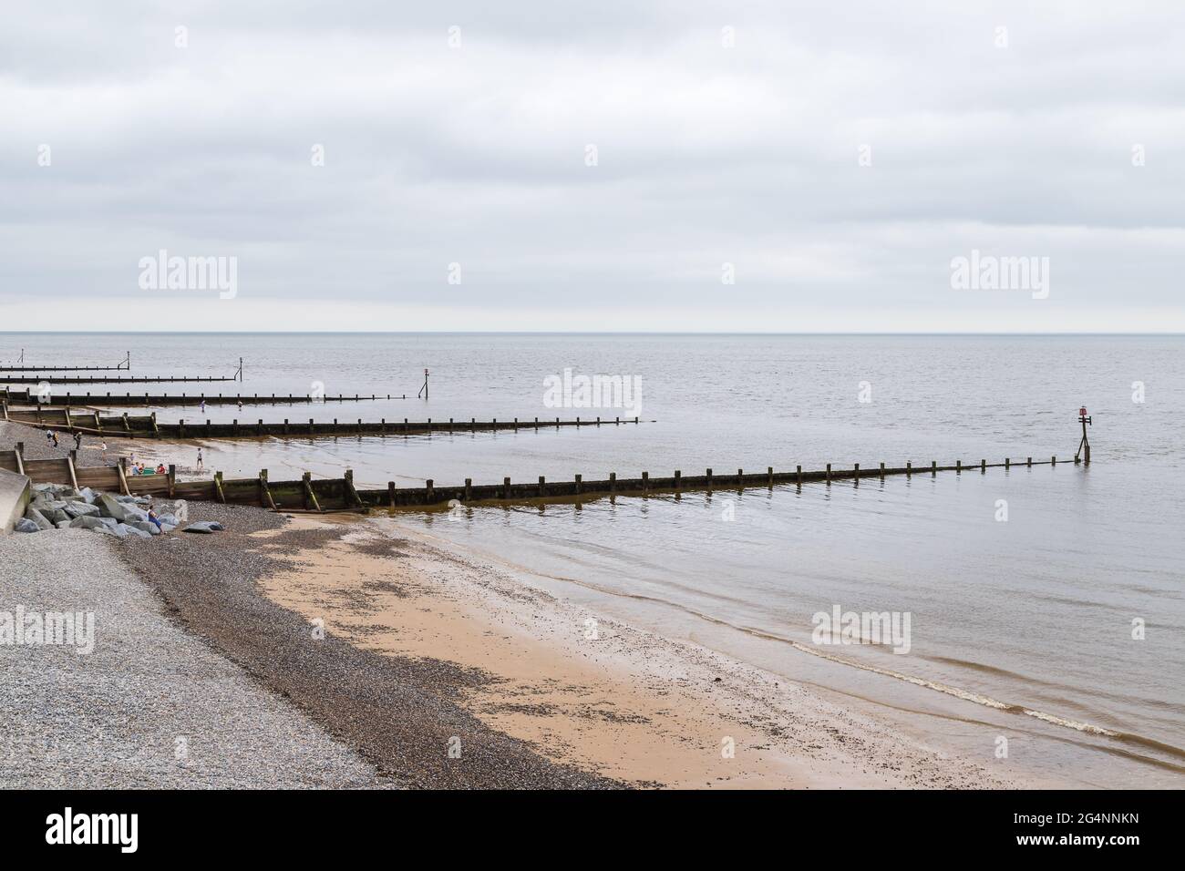 Groynes at Sheringham beach stretch out into the sea on the North ...