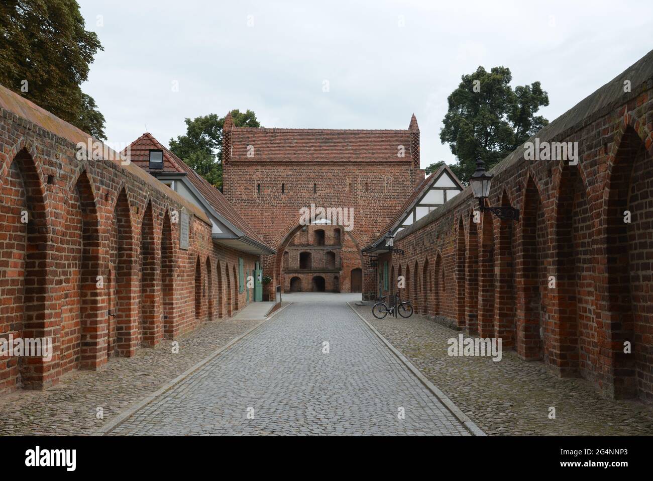 A narrow pathway through the historic Friedlaender Tor gate in the town ...