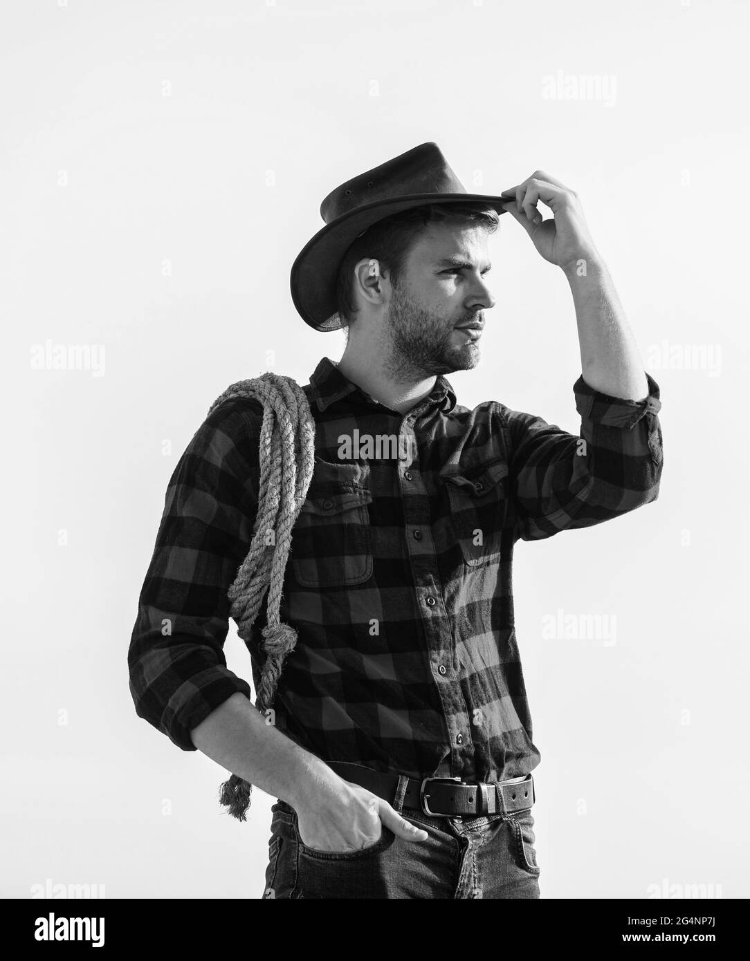 Ranch worker. Life at ranch. Cowboy with lasso rope sky background. Eco ...