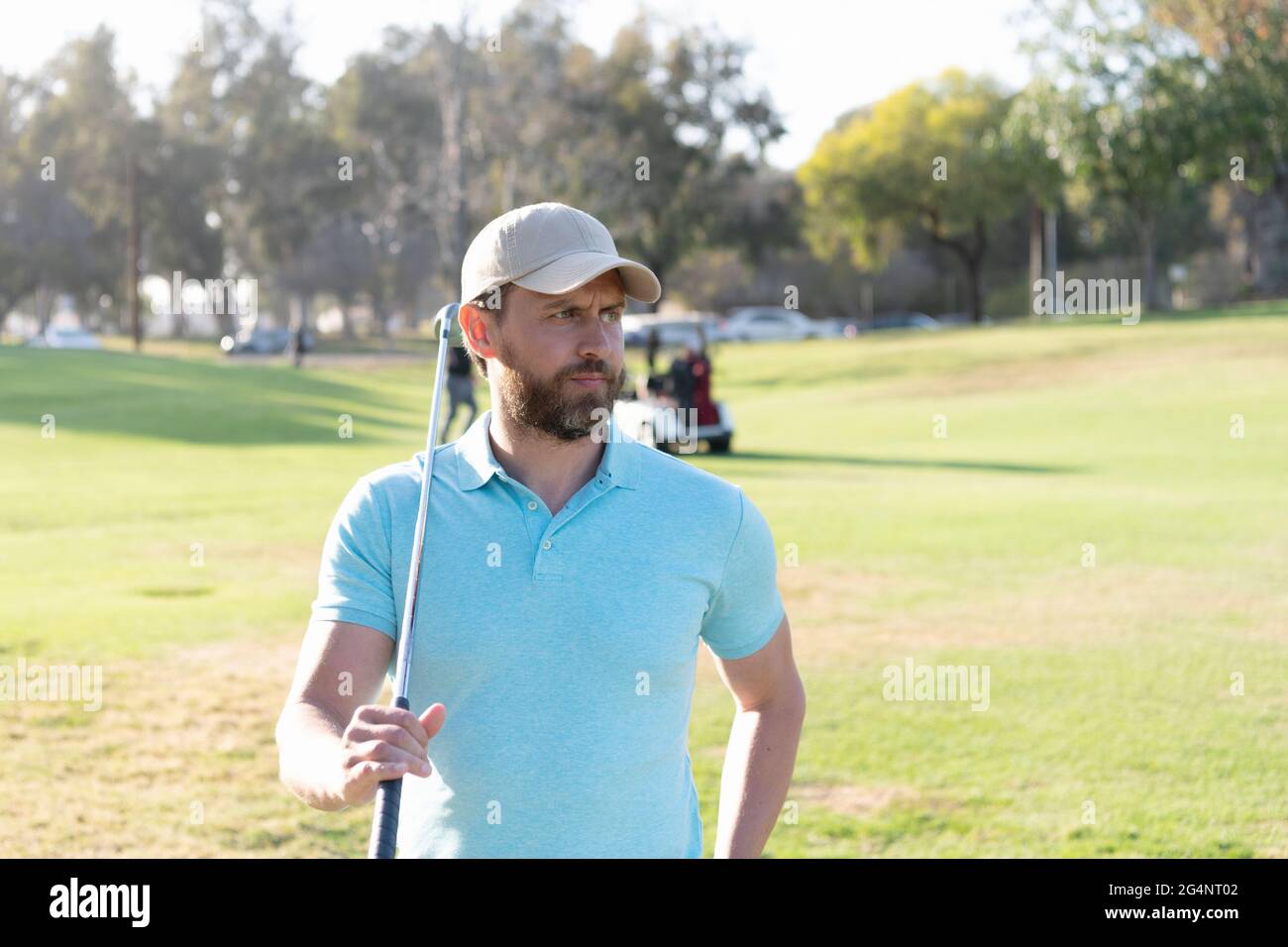 male golf player on professional golf course. portrait of golfer in cap ...