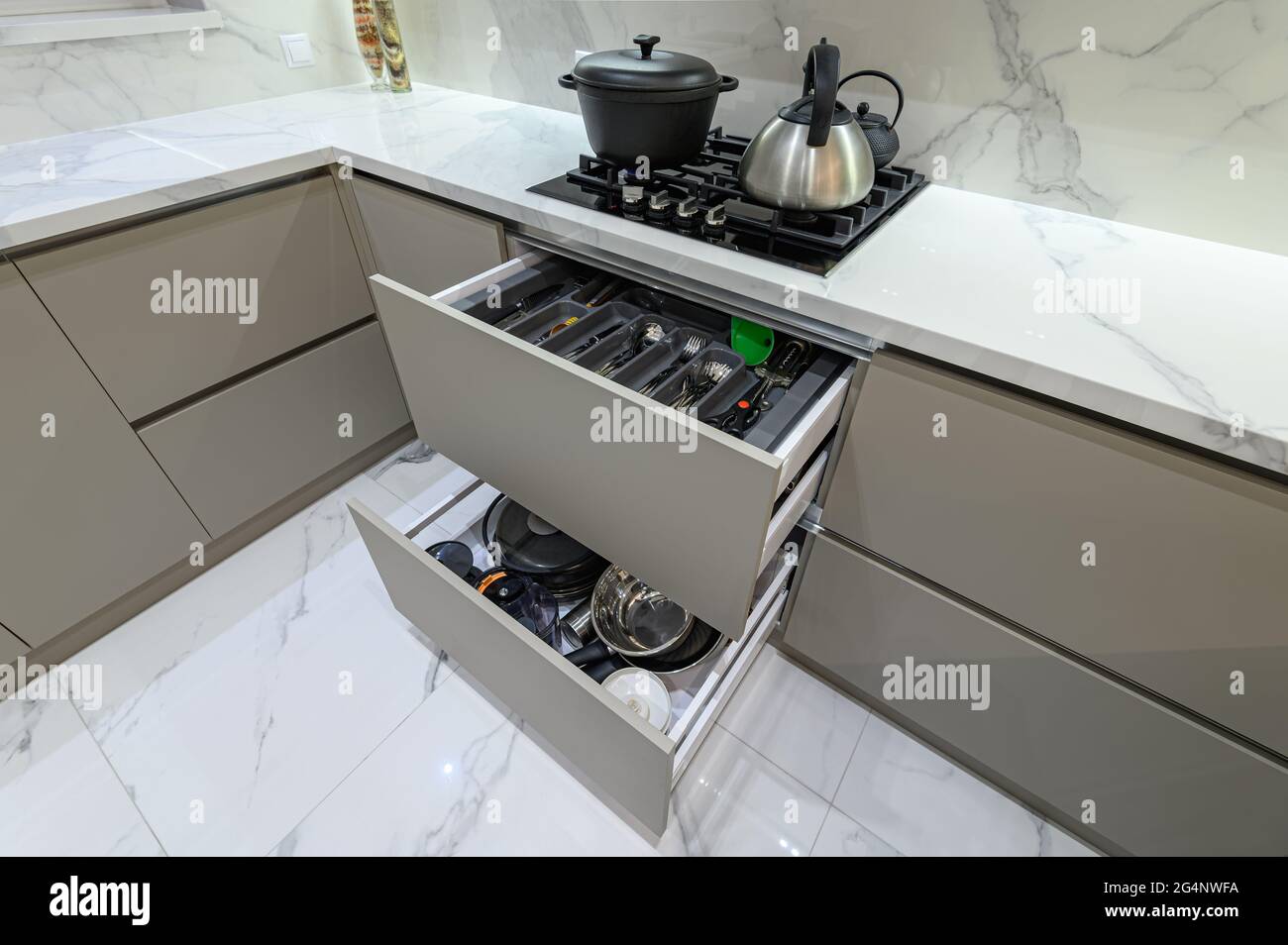 Open drawer with cutlery at modern white woden kitchen in classic style ...