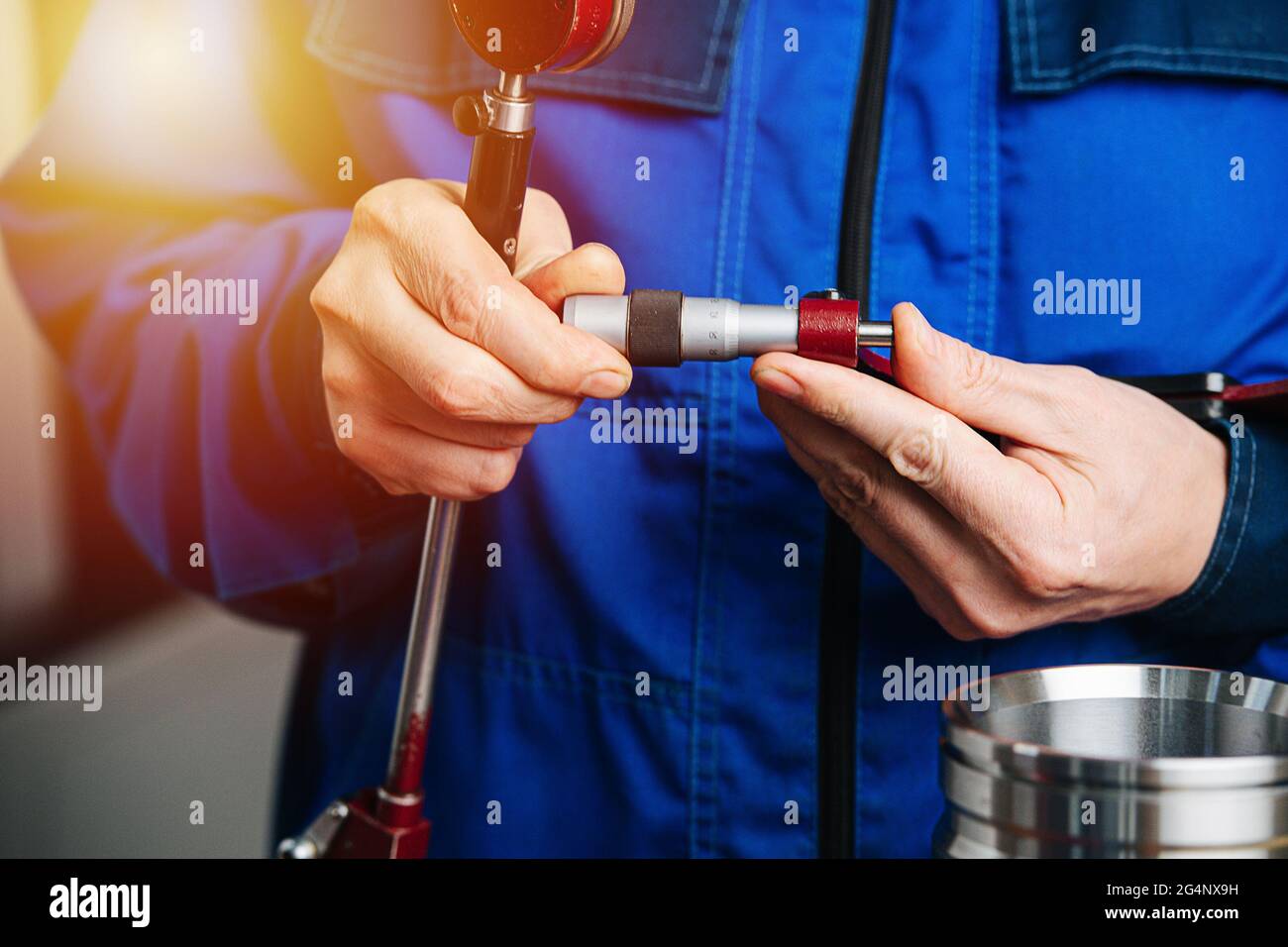 Worker assembling parts of mechanism. Cropped, no face, hands and body ...