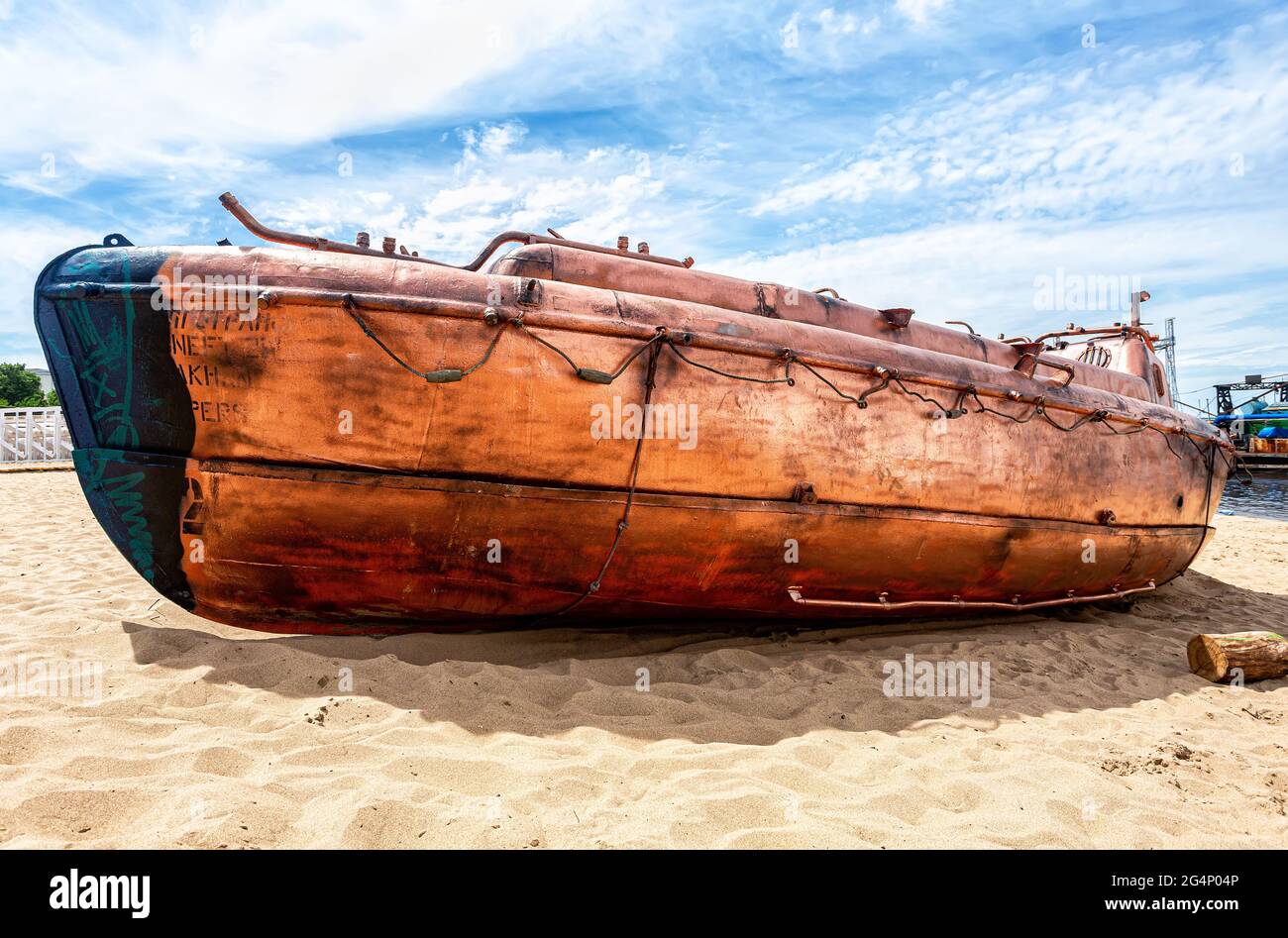 Old river motor boat on the sandy bank of the river. Broken abandoned ...
