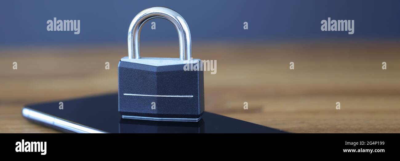 Smartphone with lock on screen is on table Stock Photo - Alamy