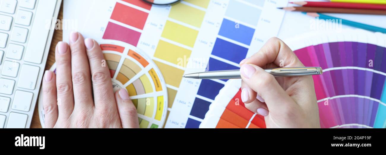 Designer develops color combinations on desktop closeup Stock Photo - Alamy