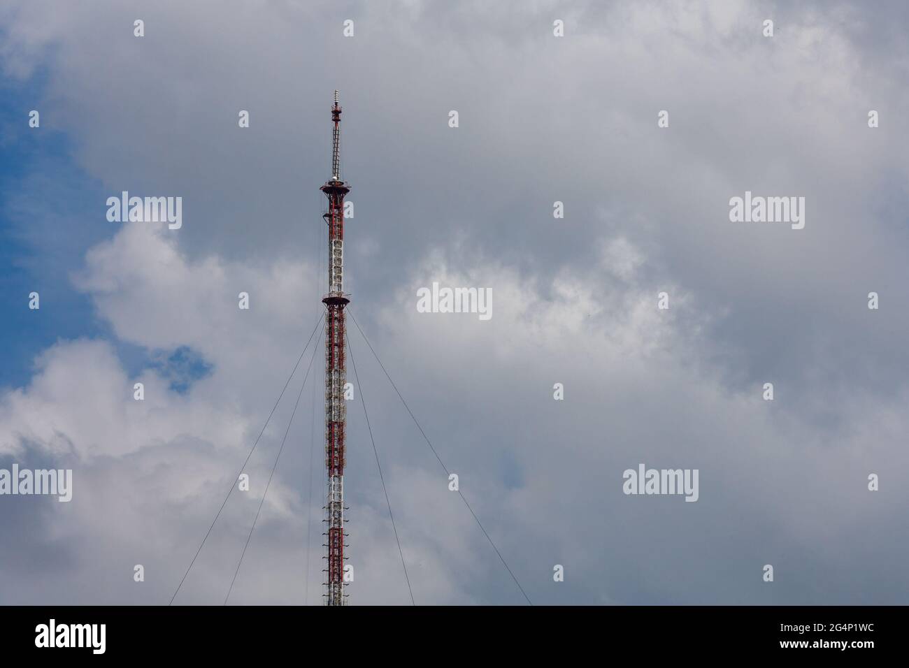 tall metal frame television tower on cloudy sky daylight background ...