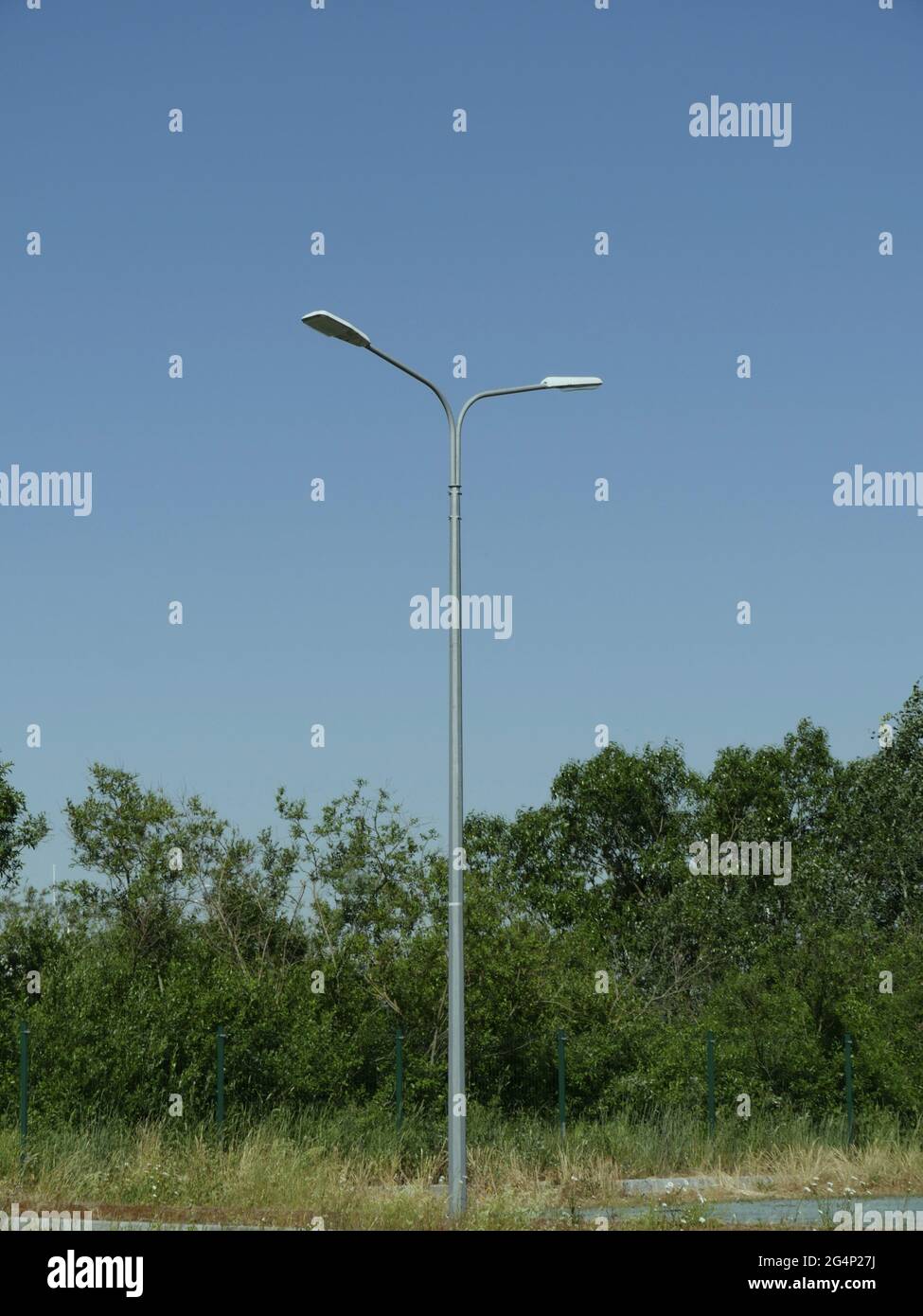 one tall electric lantern in an empty park minimalism Stock Photo - Alamy