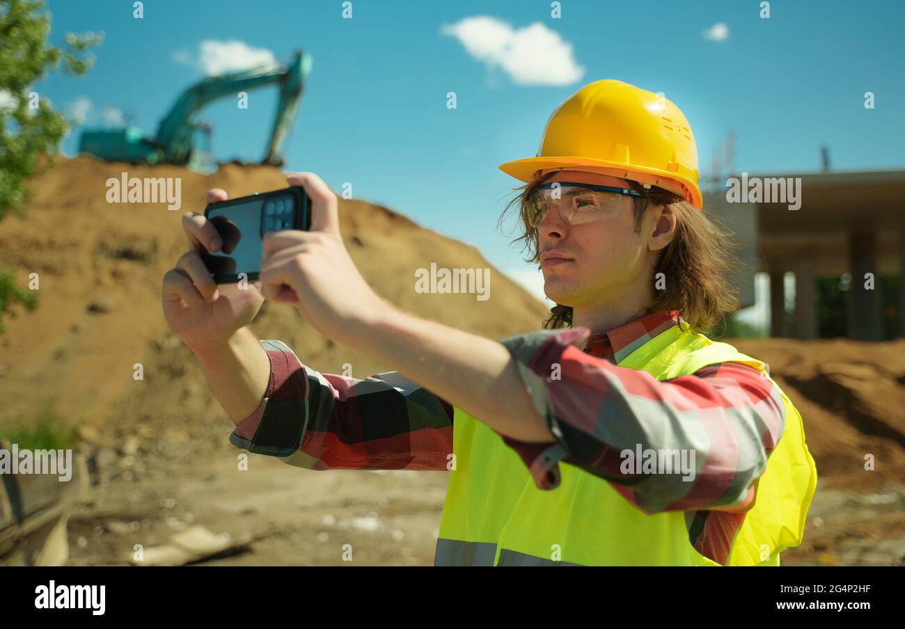 Building contractor with mobile phone shooting work they done Stock ...
