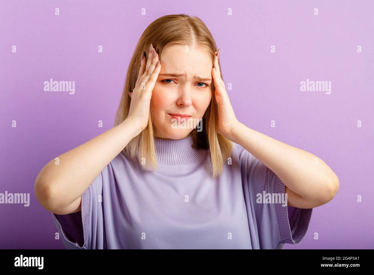 Woman experiencing stress headache holding her head. Emotional portrait ... Woman experiencing stress headache holding her head. Emotional portrait ...
