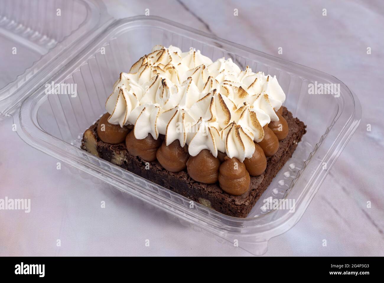 Three-layer cake with chocolate and cream in a plastic container Stock ...