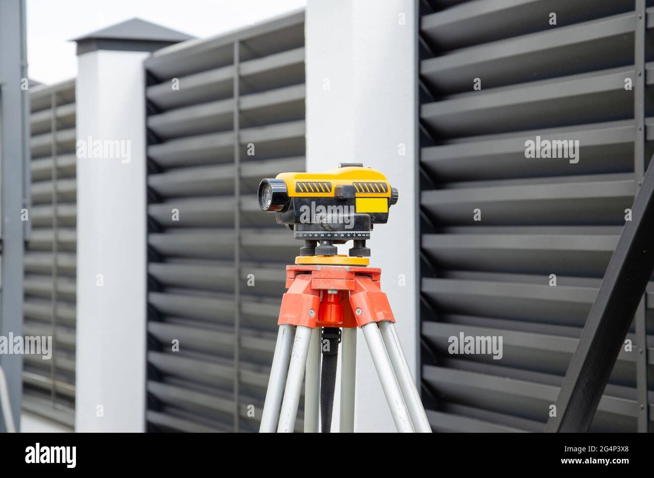 Surveying measuring equipment level transit on tripod at construction ...