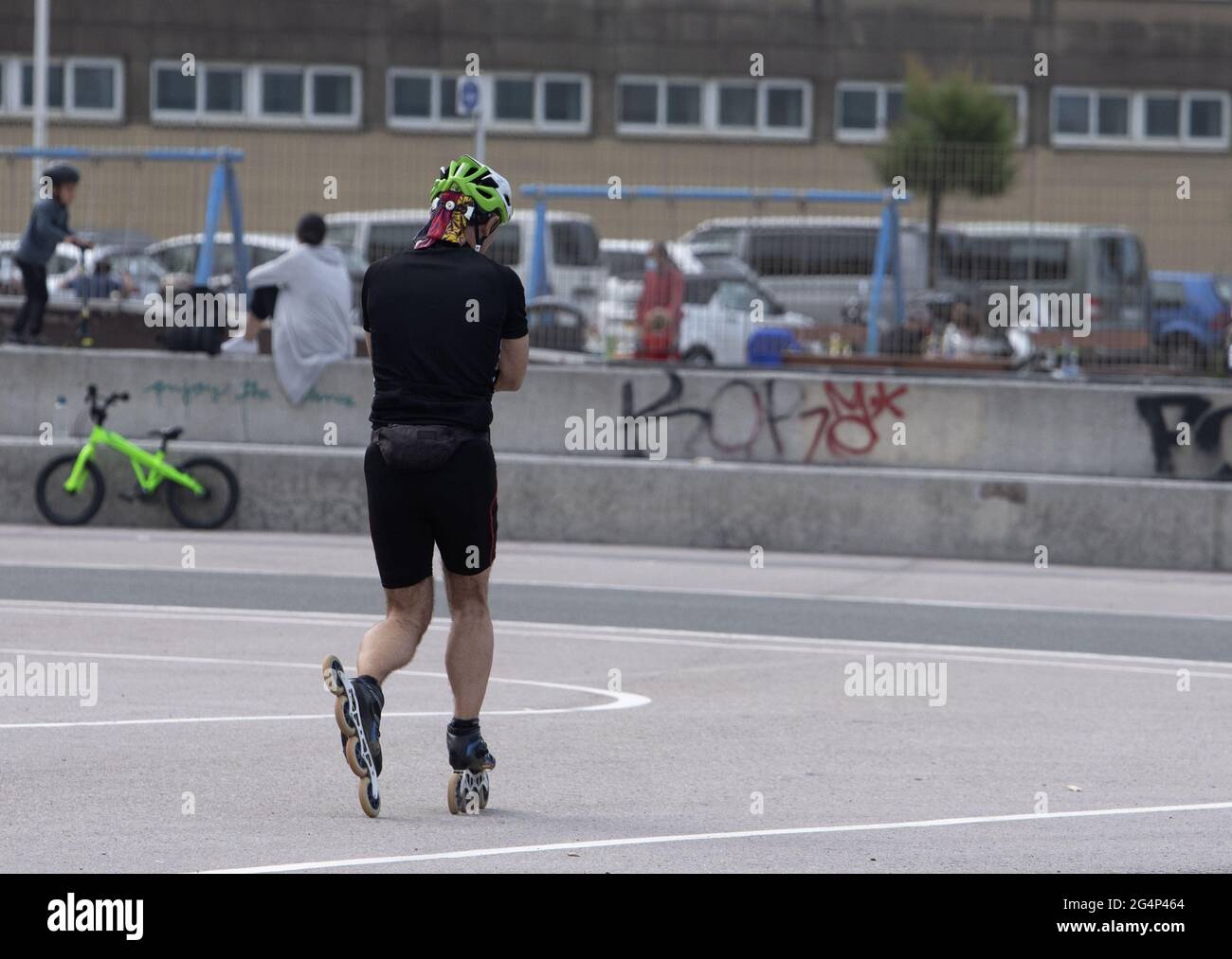 Back view of a young man in roller skates outdoors Stock Photo - Alamy