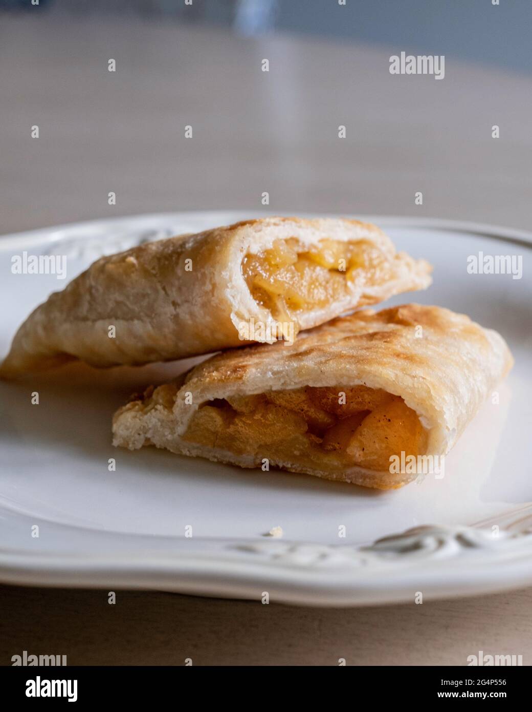 Homemade fried apple pie cut in half made from dried apples with flaky ...