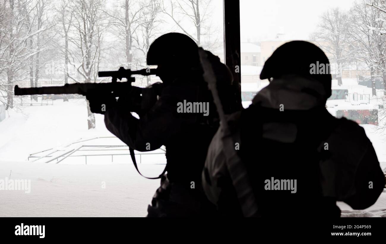 Snipers in a building looking for a shooting position during a sniper ...