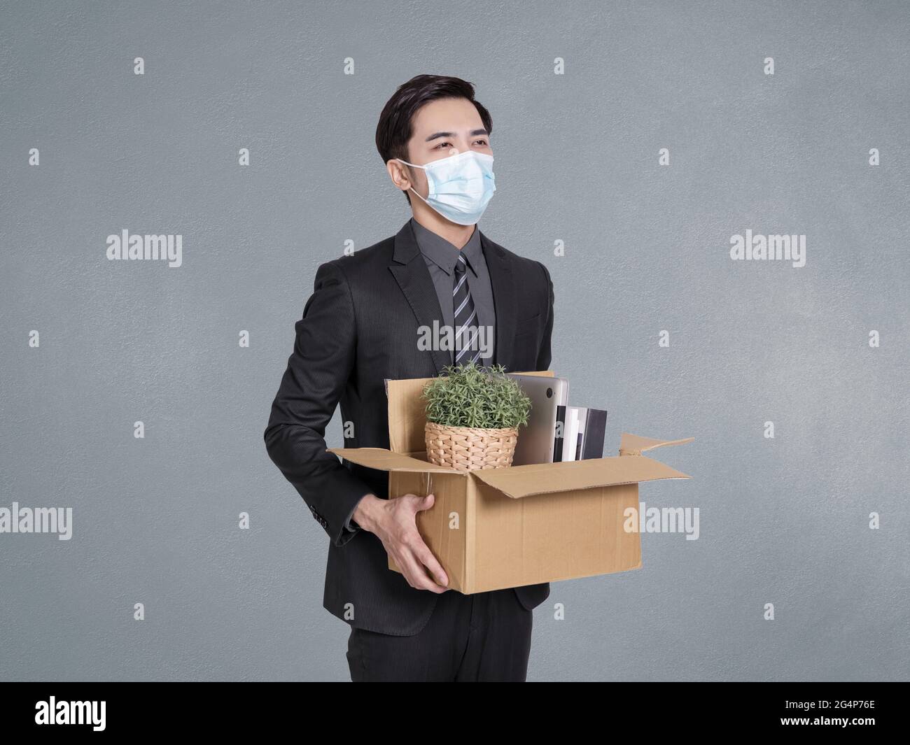 Young business man loss job, holding cardboard box with office supplies ...