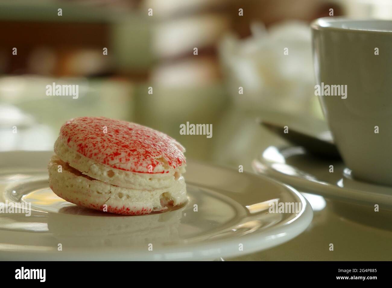 Closeup shot of a pink macaroon on a plate Stock Photo - Alamy
