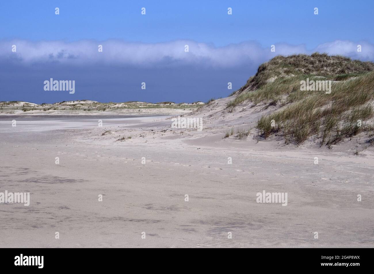 White sandy road by a deserted hill under a blue sky Stock Photo - Alamy