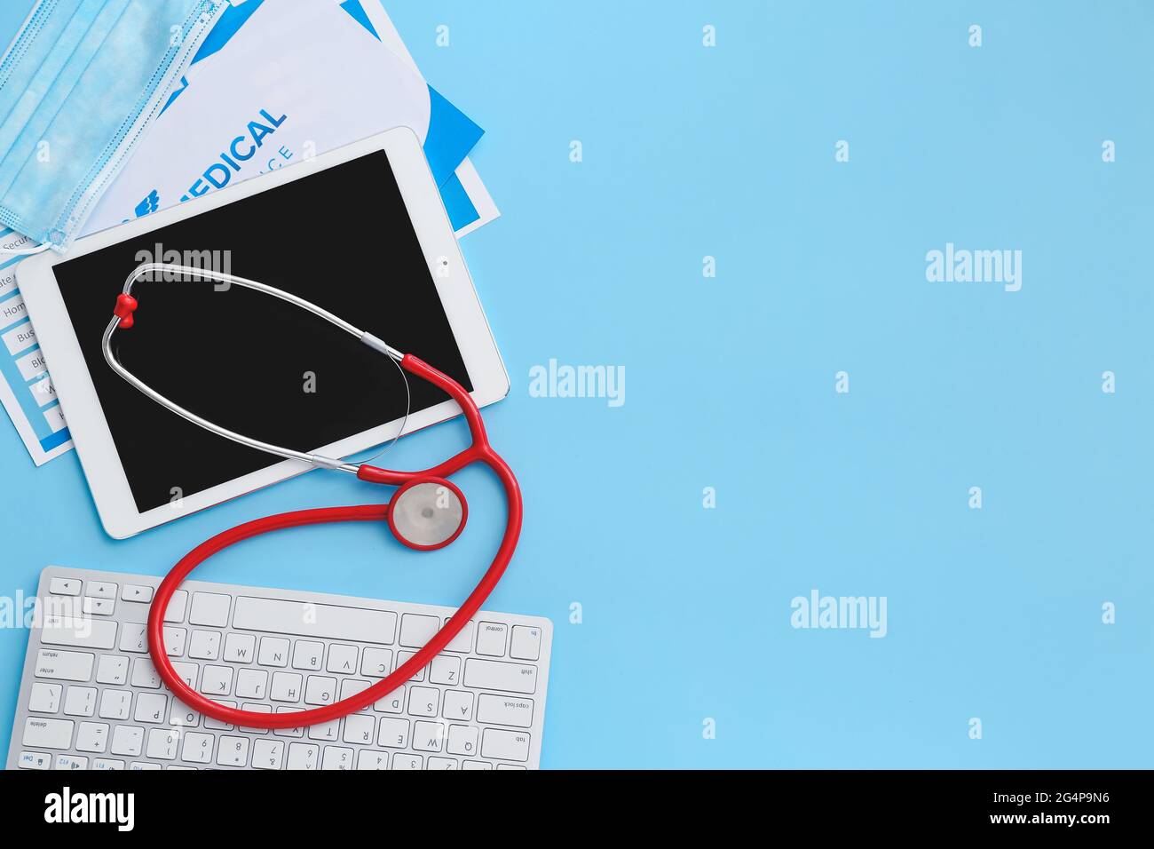 Tablet computer with stethoscope and accessories of doctor on color ...