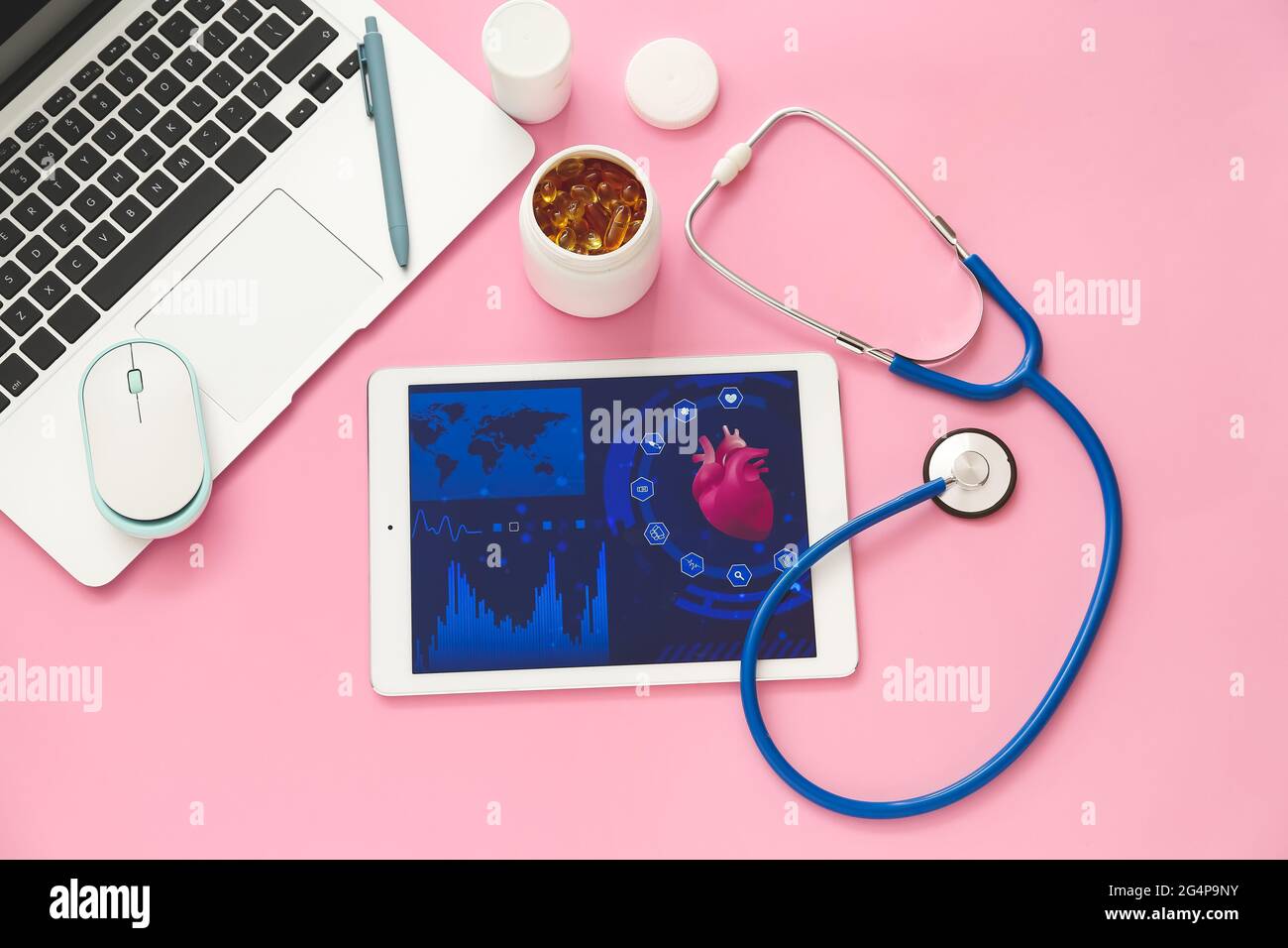 Tablet computer with stethoscope, laptop and pills on color background ...