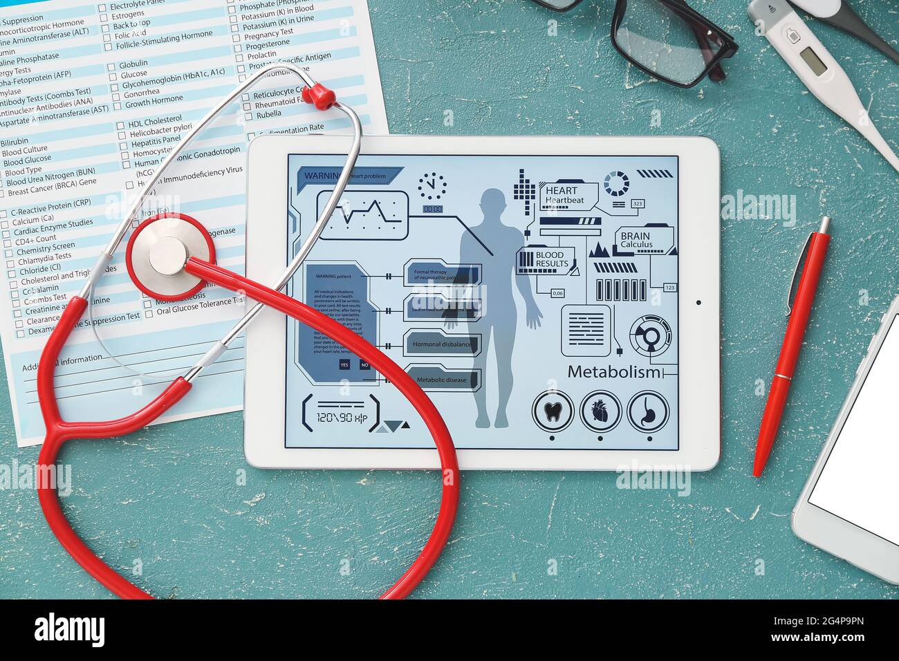 Tablet computer with stethoscope and laboratory test form on color ...