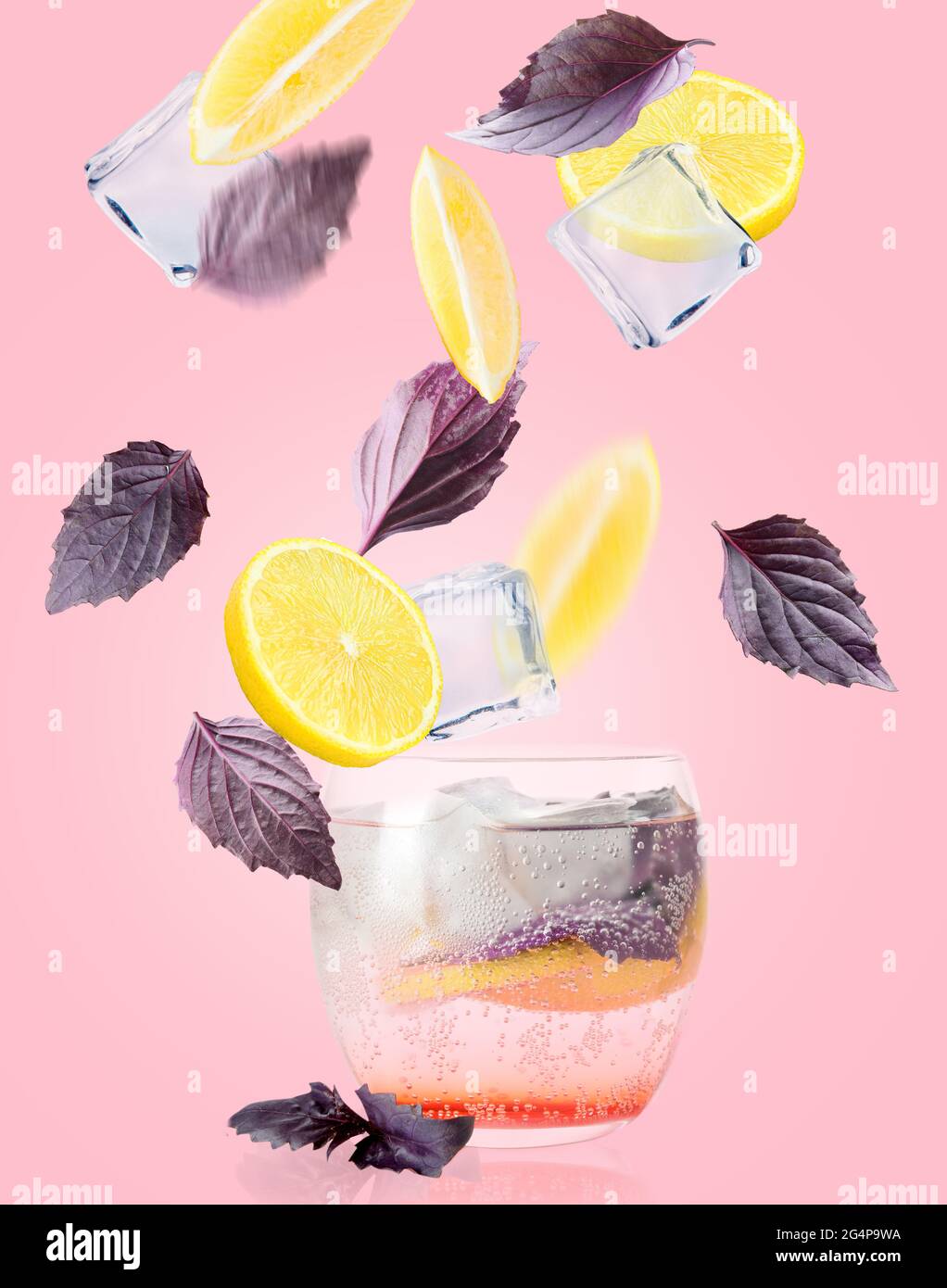Glass of tasty lemonade with flying ingredients on color background ...