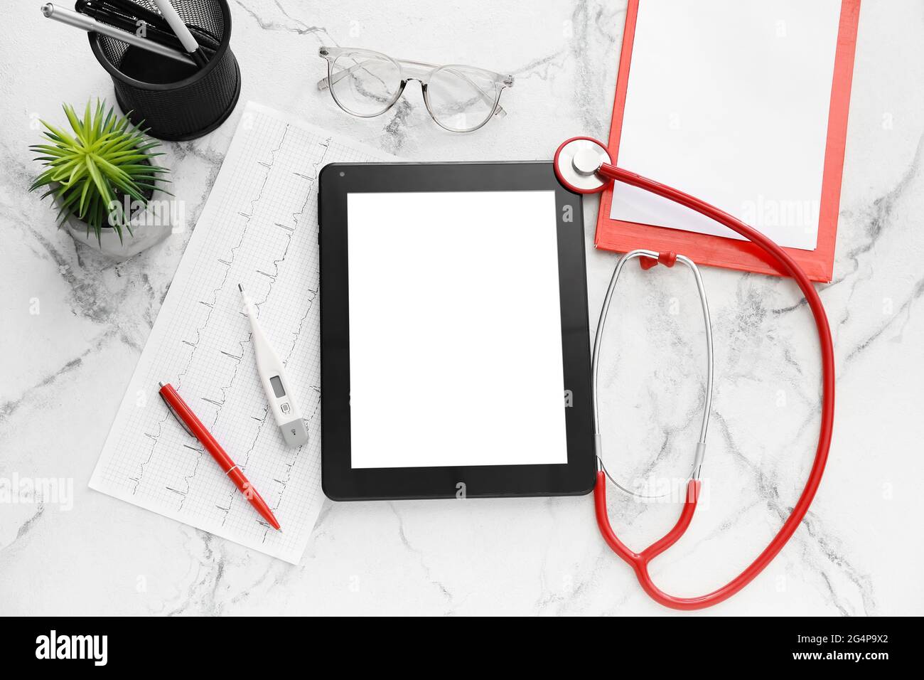 Tablet computer with stethoscope, cardiogram and accessories of doctor ...