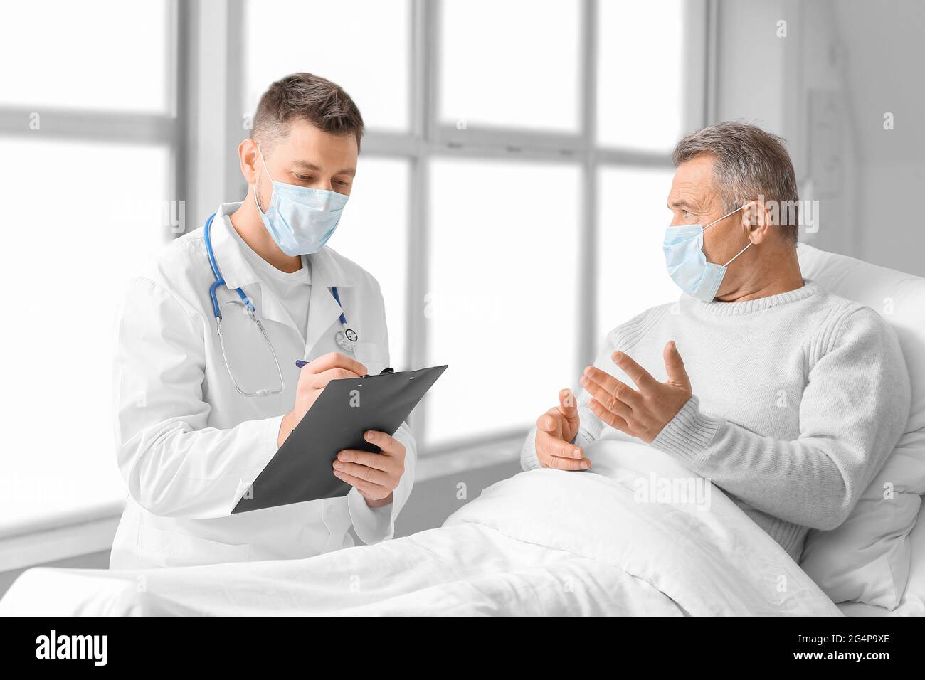 Doctor and mature man undergoing course of chemotherapy in clinic Stock ...