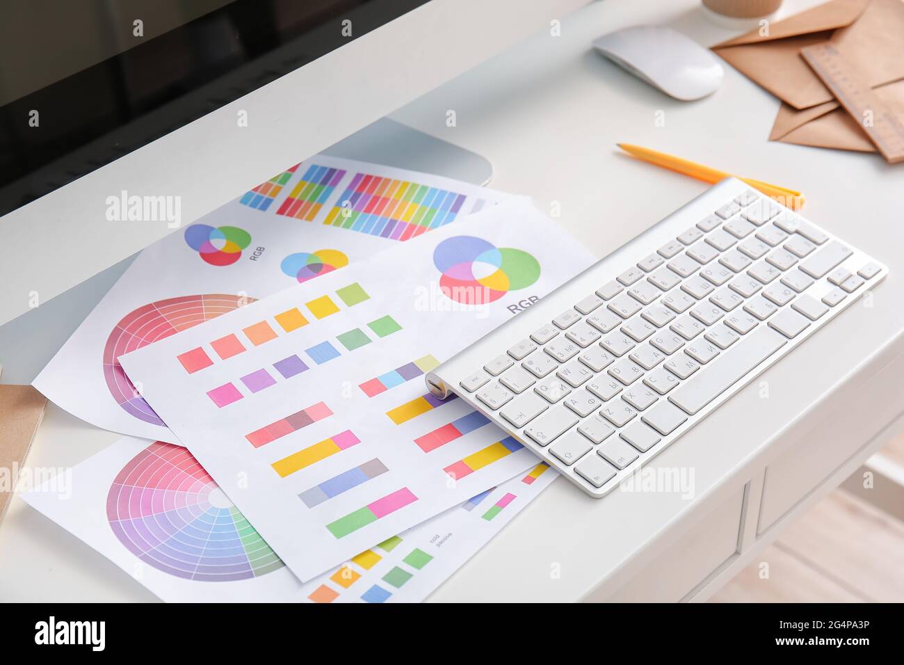 Computer with color swatches at workplace of graphic designer in office ...