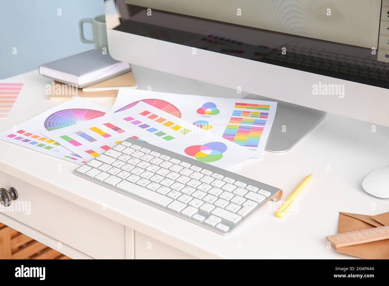 Computer with color swatches at workplace of graphic designer in office ...