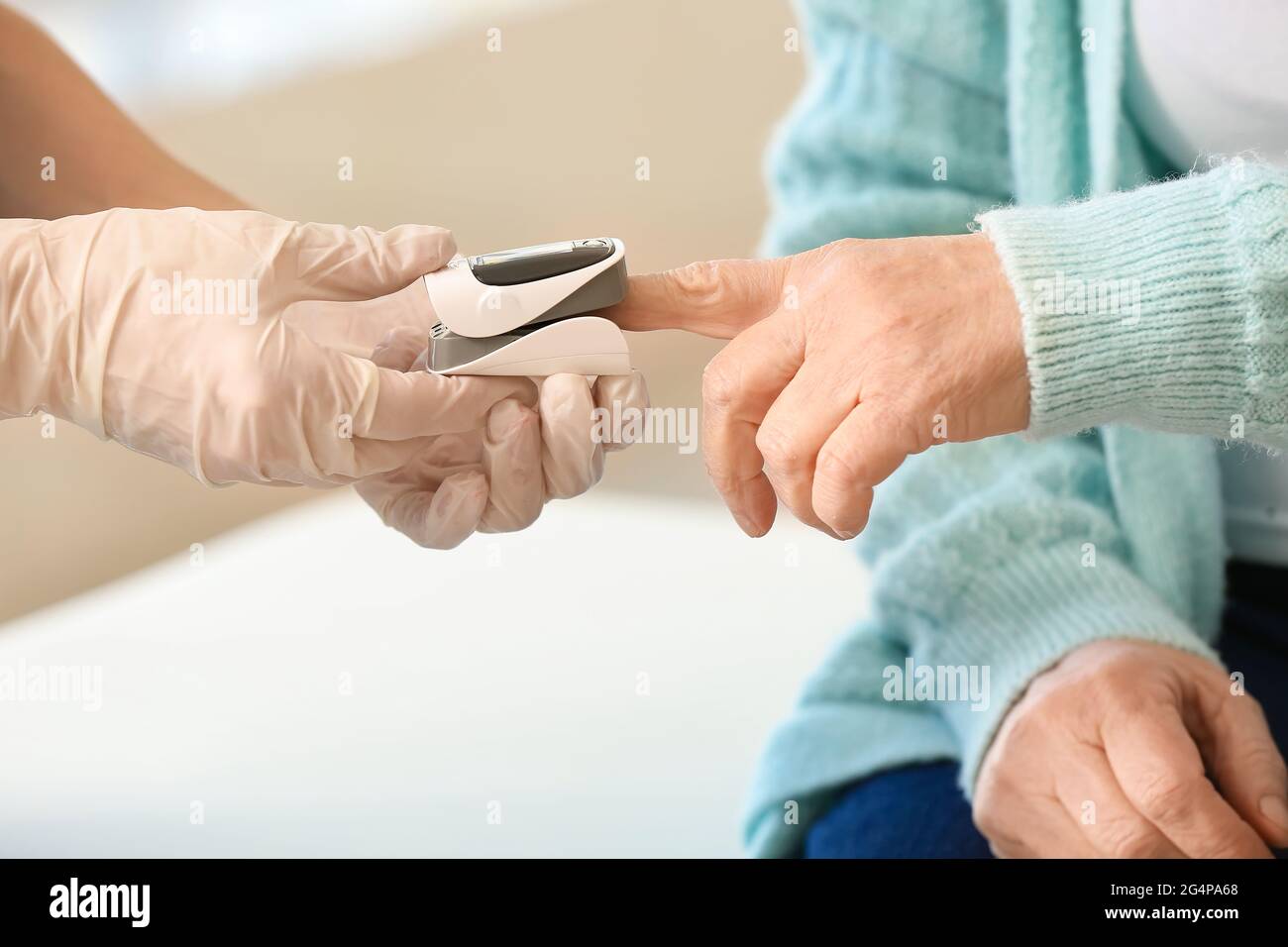Doctor measuring oxygen saturation level of patient blood in clinic ...