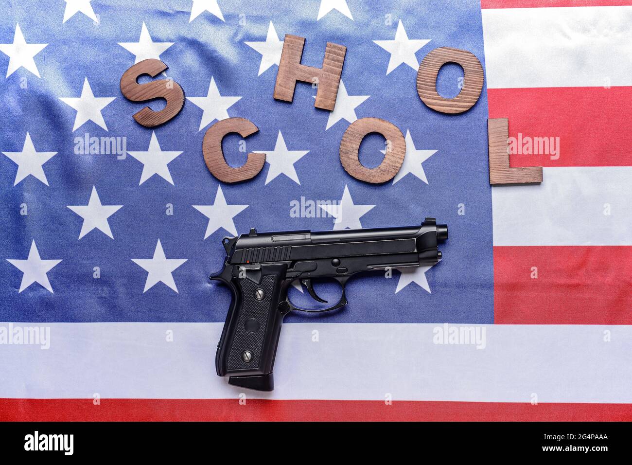 Pistol and flag of USA. Concept of school shooting Stock Photo - Alamy