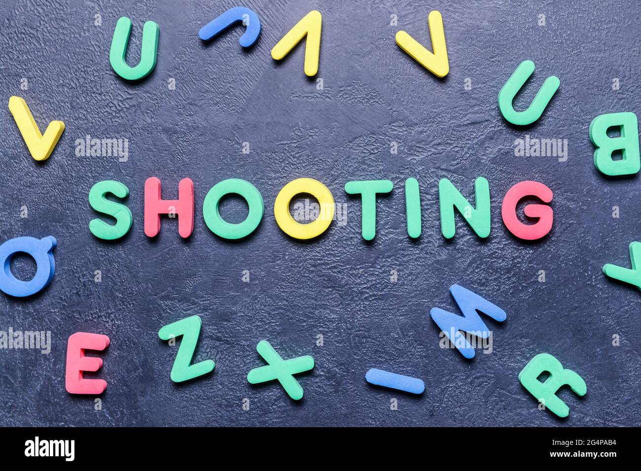 Word SHOOTING on dark background Stock Photo - Alamy